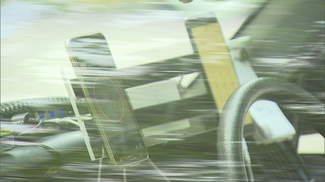 Only two mobile communication devices placed in front of driver from ...